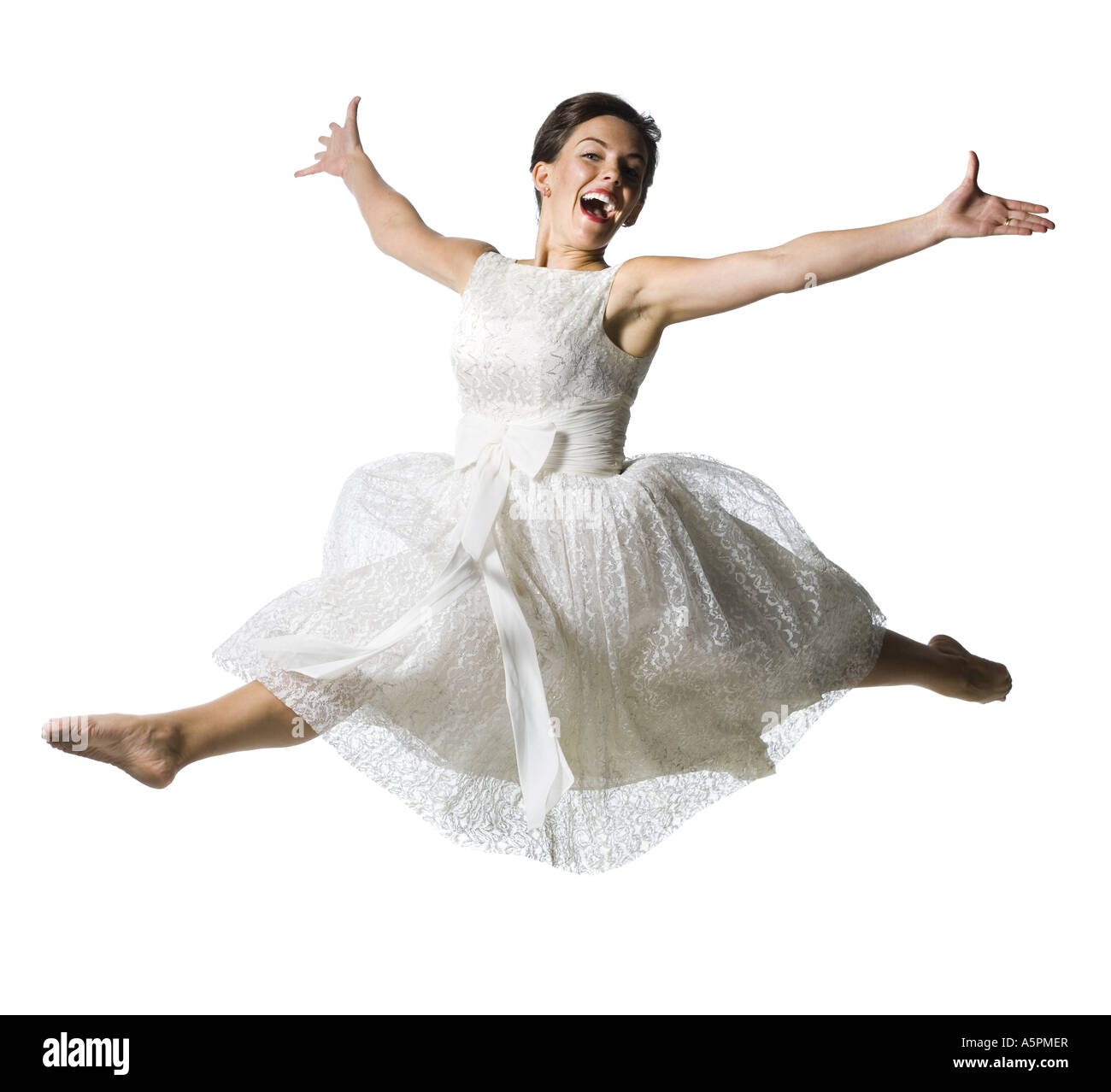Woman in white dress jumping Stock Photo - Alamy