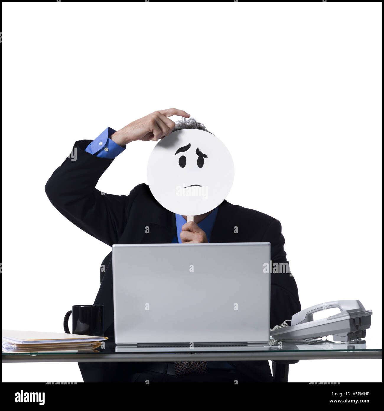 Businessman with confused face mask working on laptop Stock Photo - Alamy
