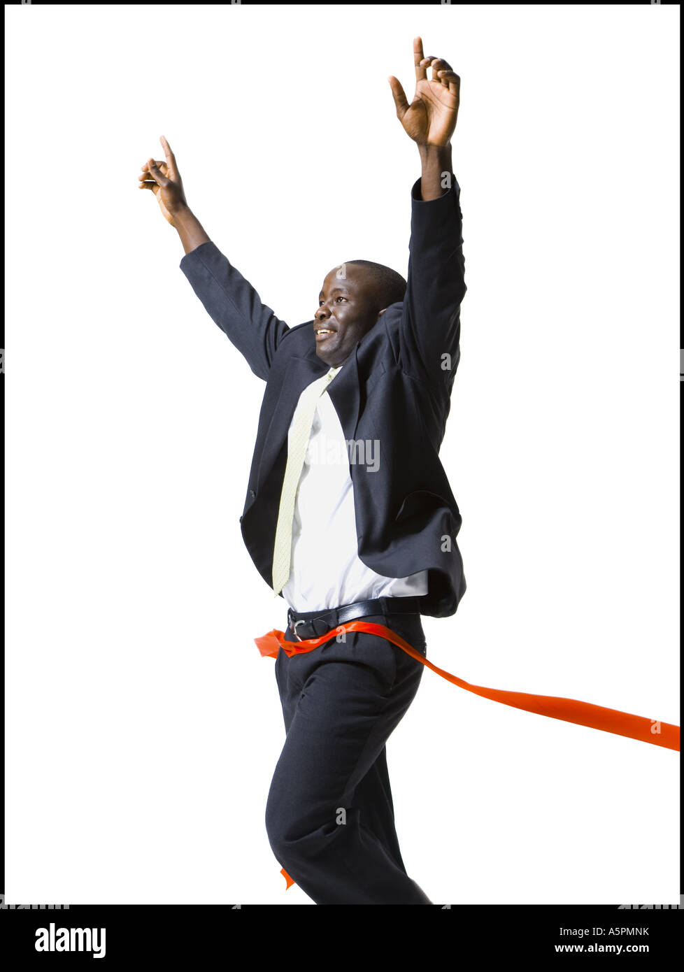 A running businessman takes first place as he crosses the finish line ...