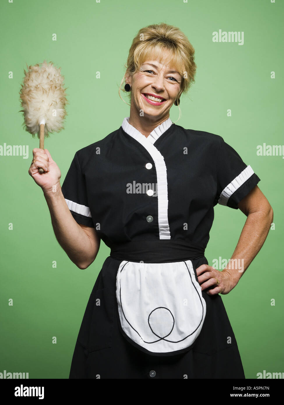 Female housekeeper with feather duster Stock Photo - Alamy