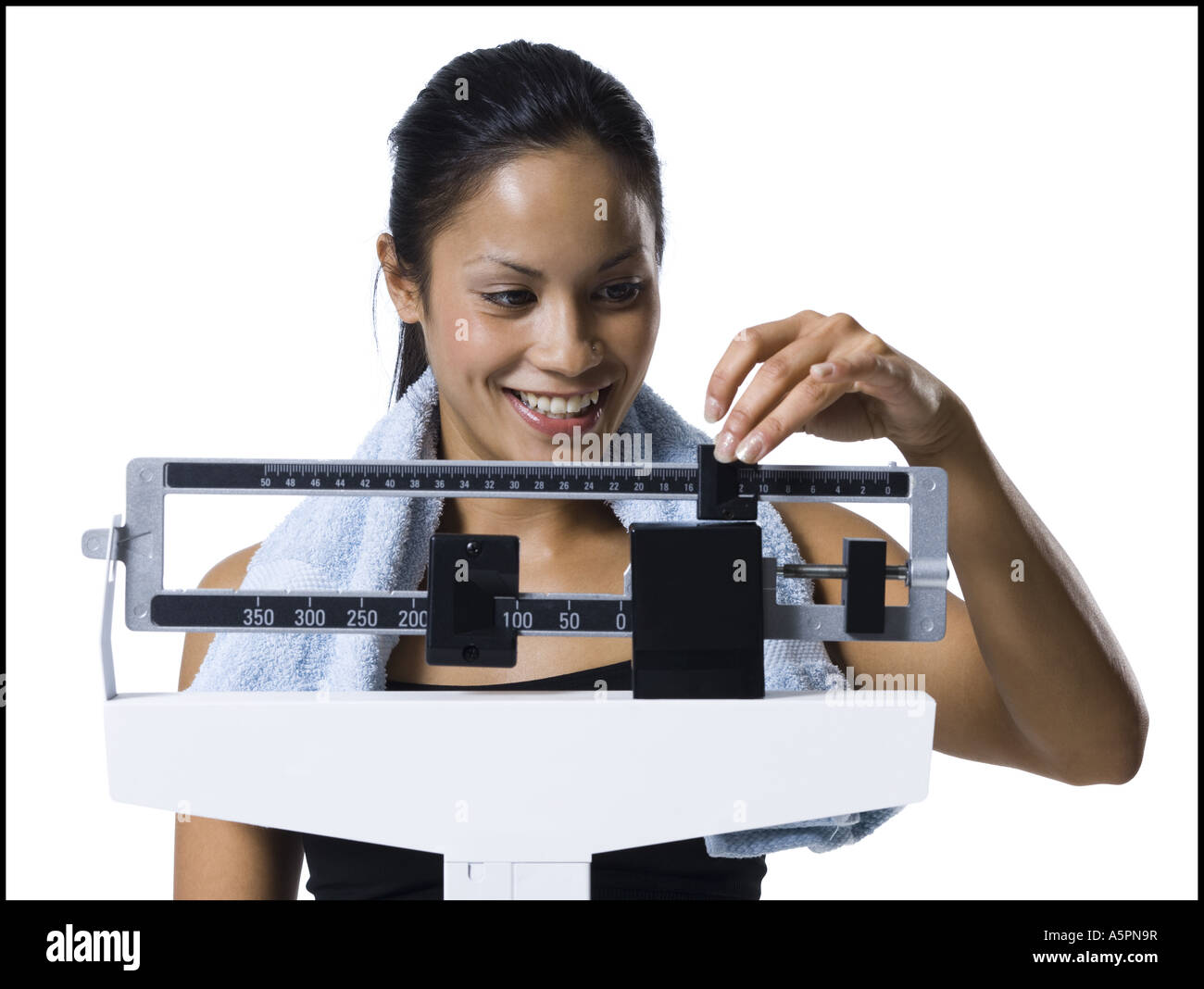 Woman weighing herself on scale Stock Photo - Alamy