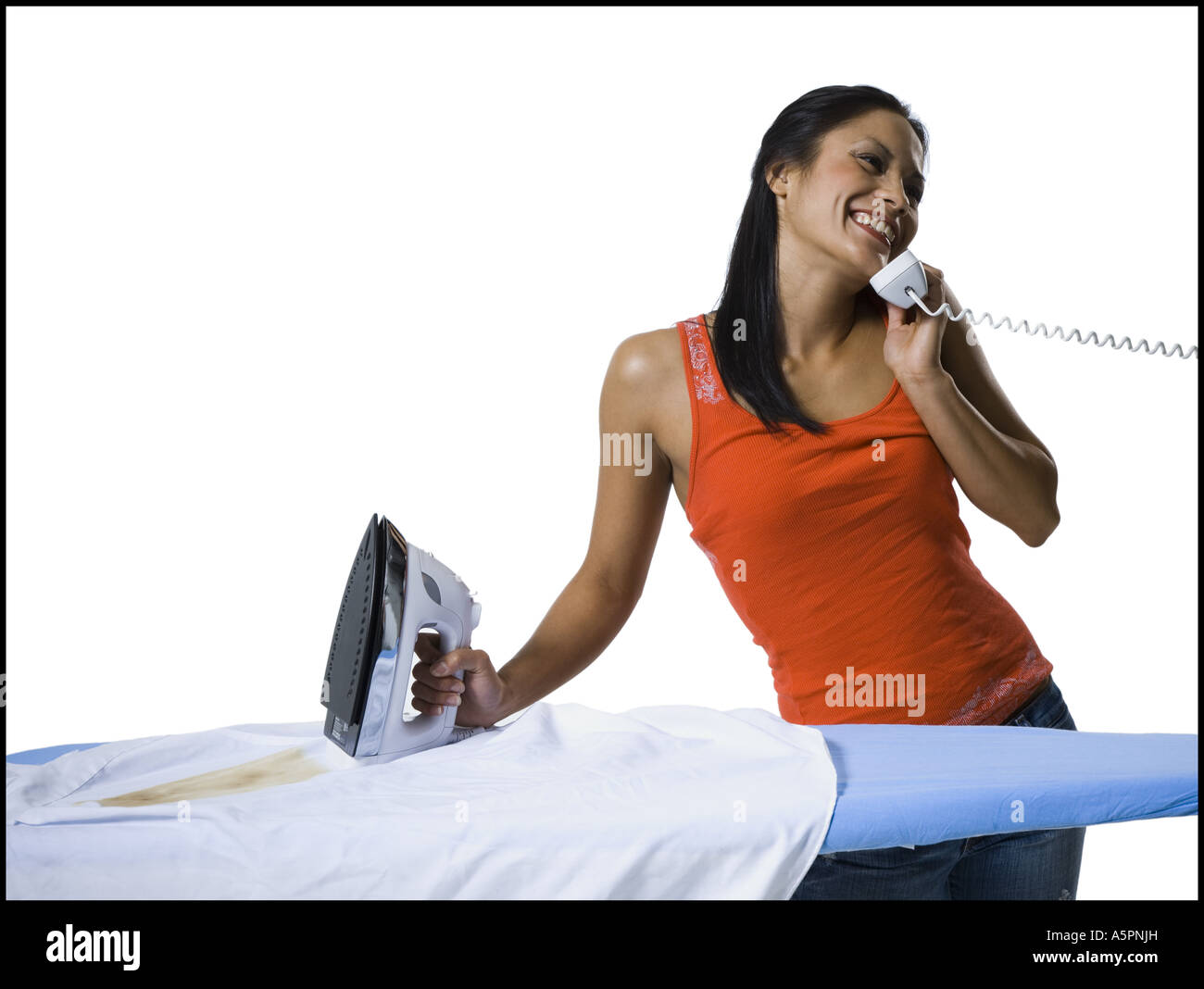 Distracted woman with iron and burned clothing Stock Photo - Alamy