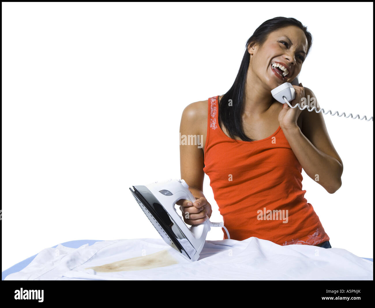 Distracted woman with iron and burned clothing Stock Photo - Alamy