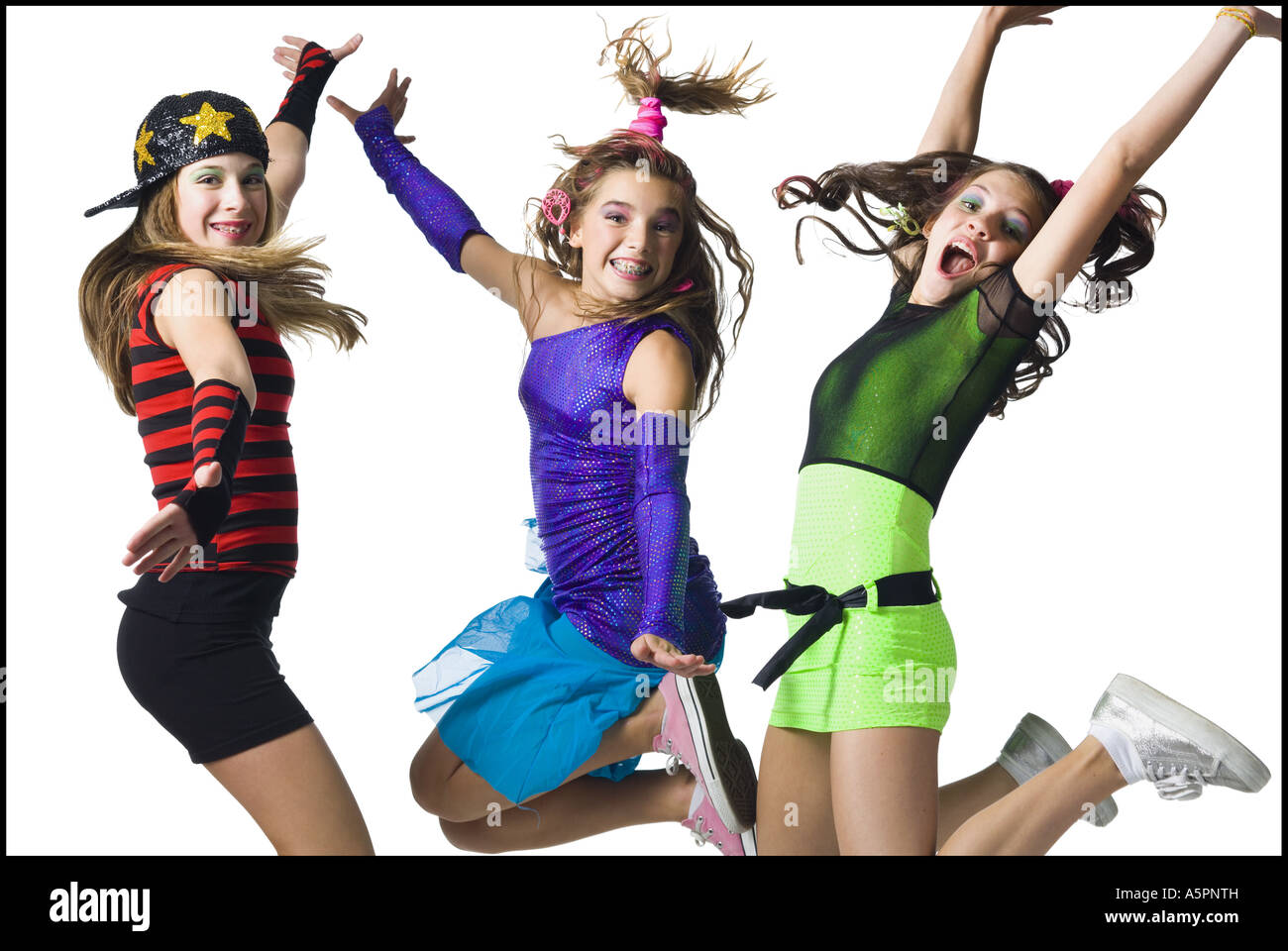Three girls leaping with costumes Stock Photo - Alamy