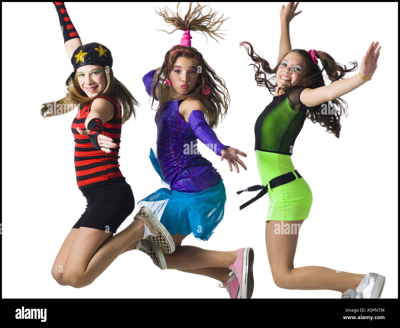 Three girls leaping with costumes Stock Photo - Alamy