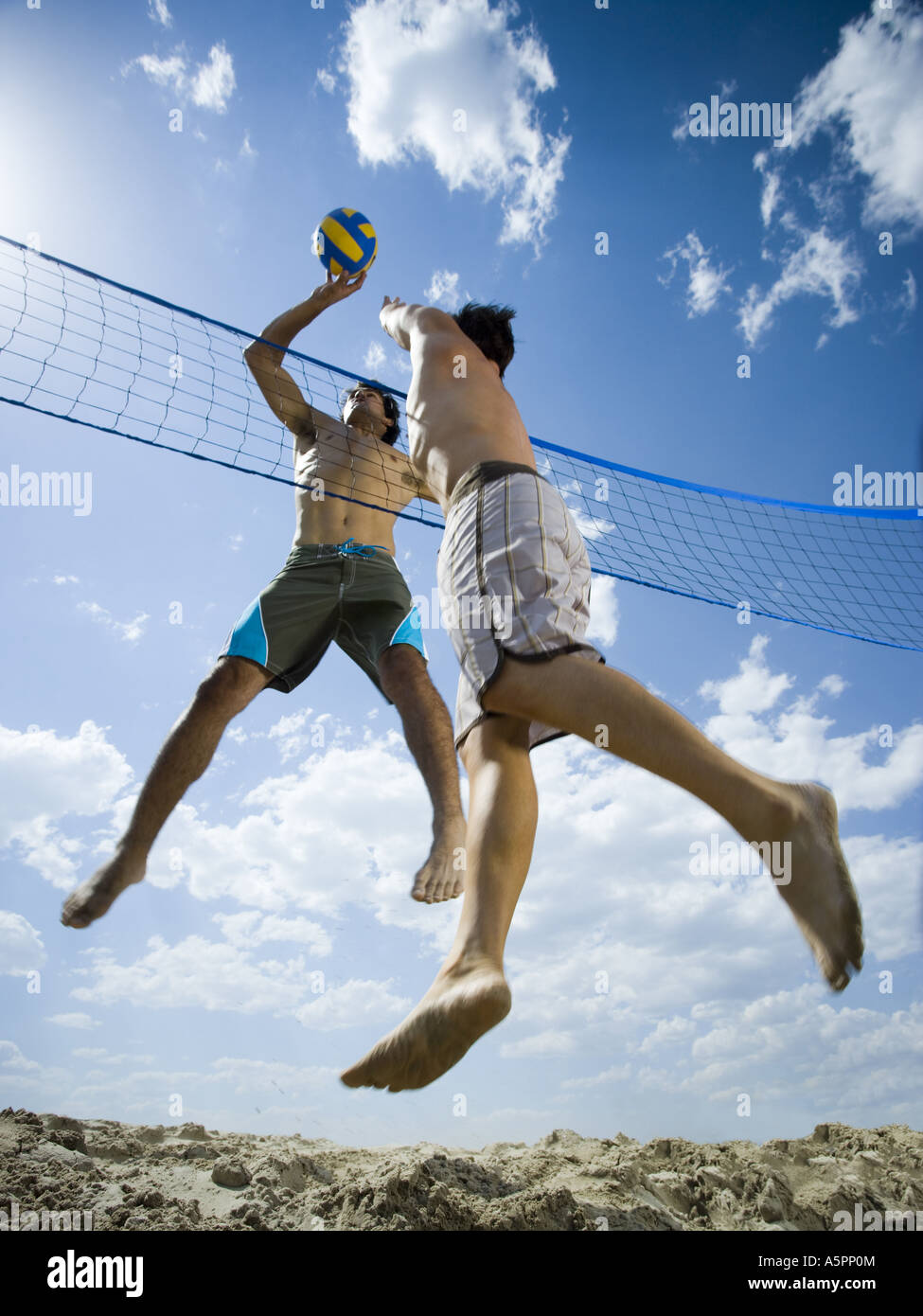 Jumping volleyball players Stock Photo - Alamy