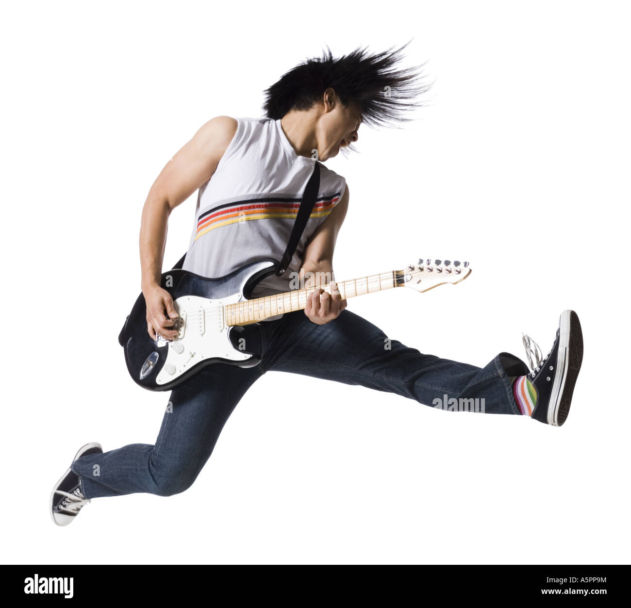 Man playing electric guitar and jumping Stock Photo - Alamy
