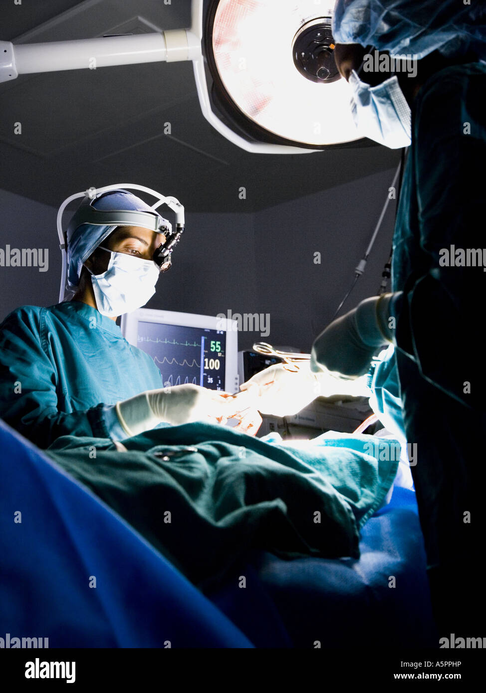 Female surgeon during surgery Stock Photo - Alamy