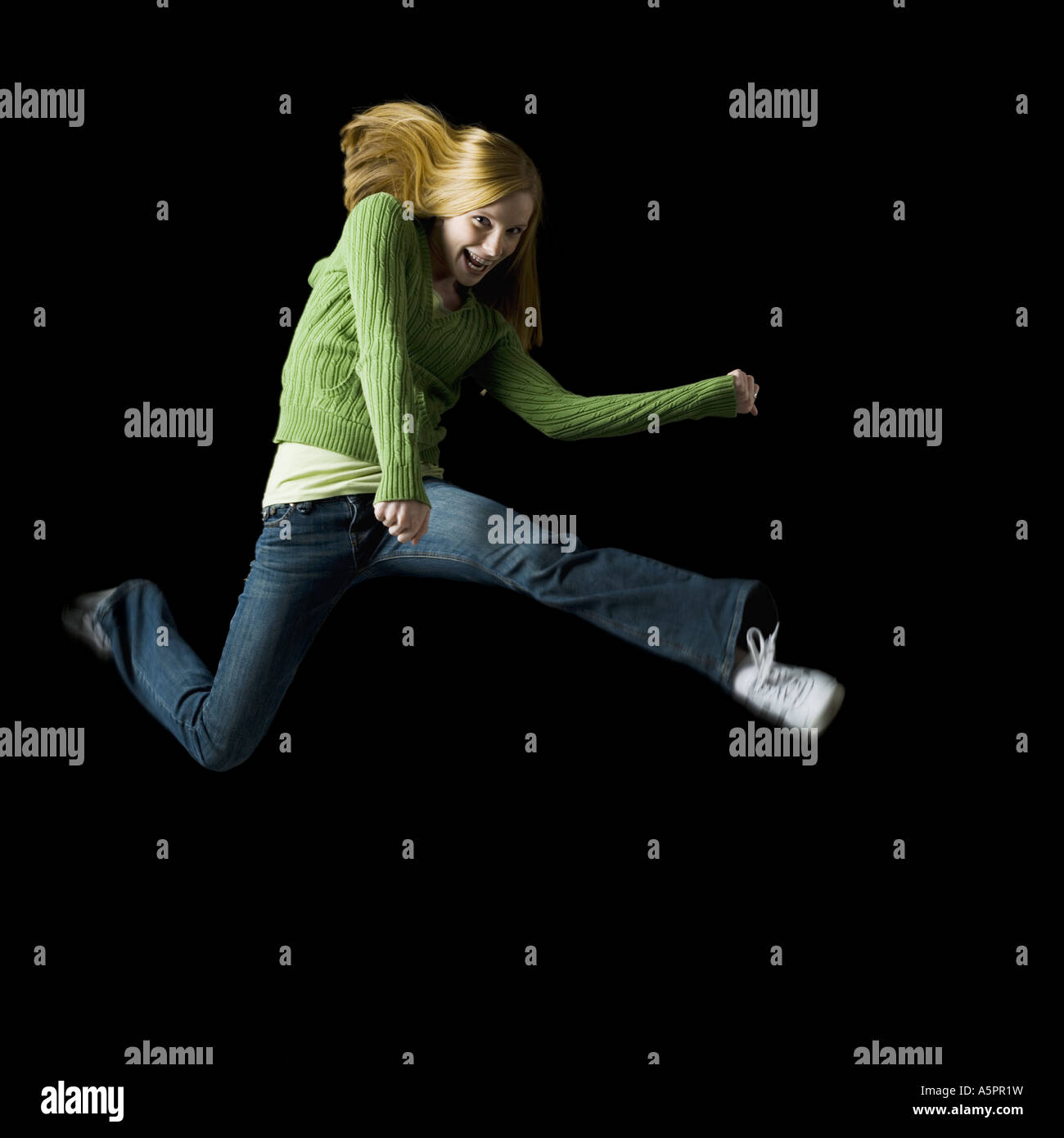 Girl leaping and smiling Stock Photo - Alamy