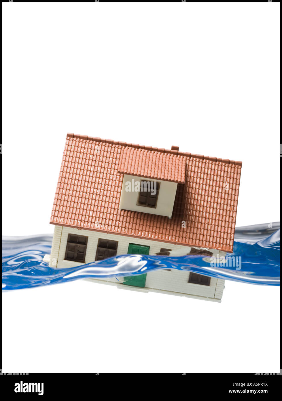 Flooded toy house floating in water Stock Photo - Alamy