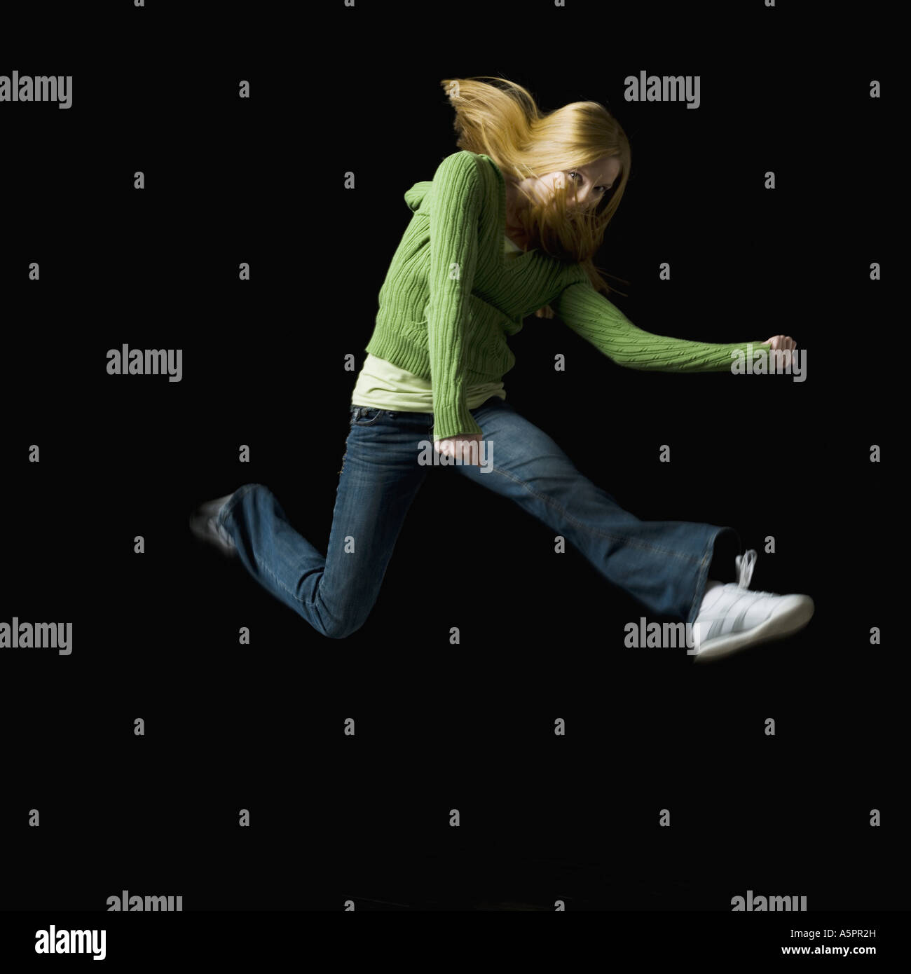 Girl leaping and smiling Stock Photo - Alamy
