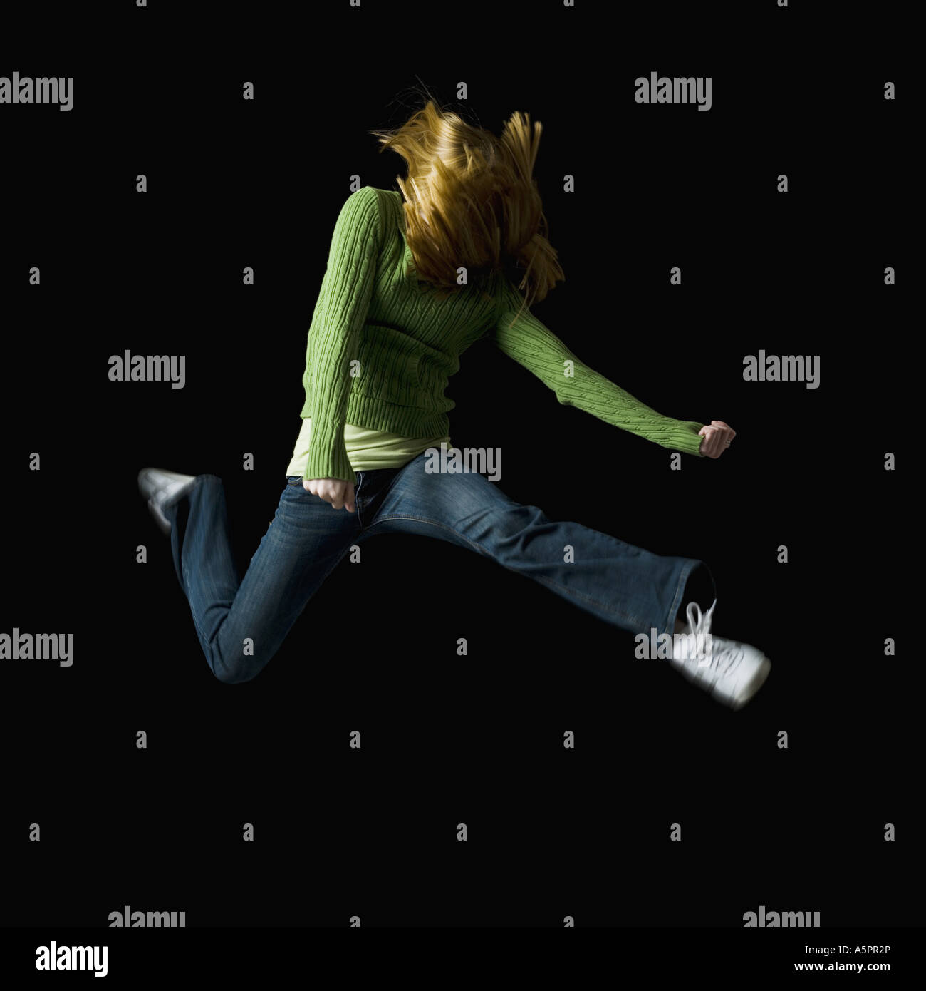 Girl leaping and smiling Stock Photo - Alamy