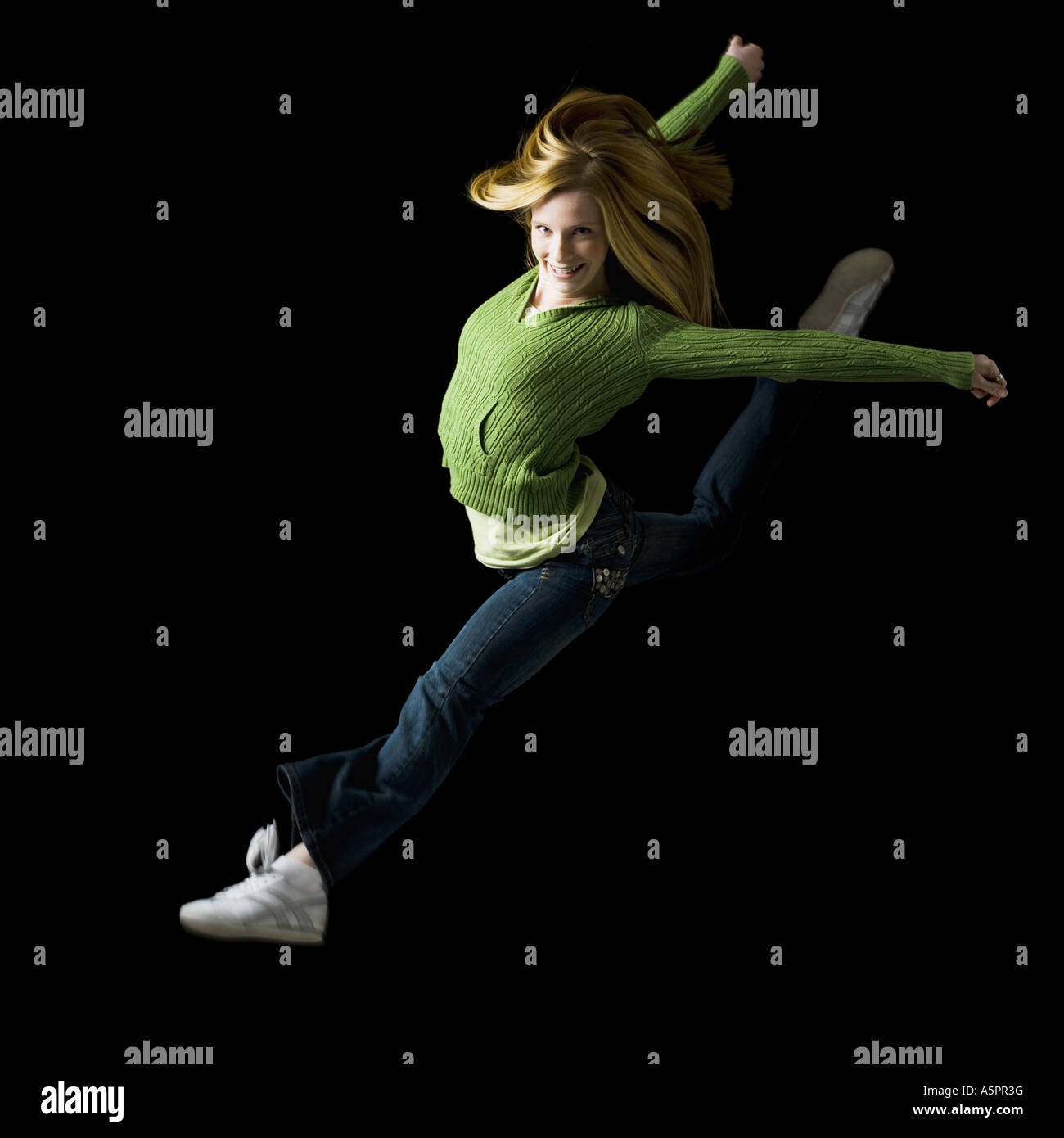 Girl leaping and smiling Stock Photo - Alamy