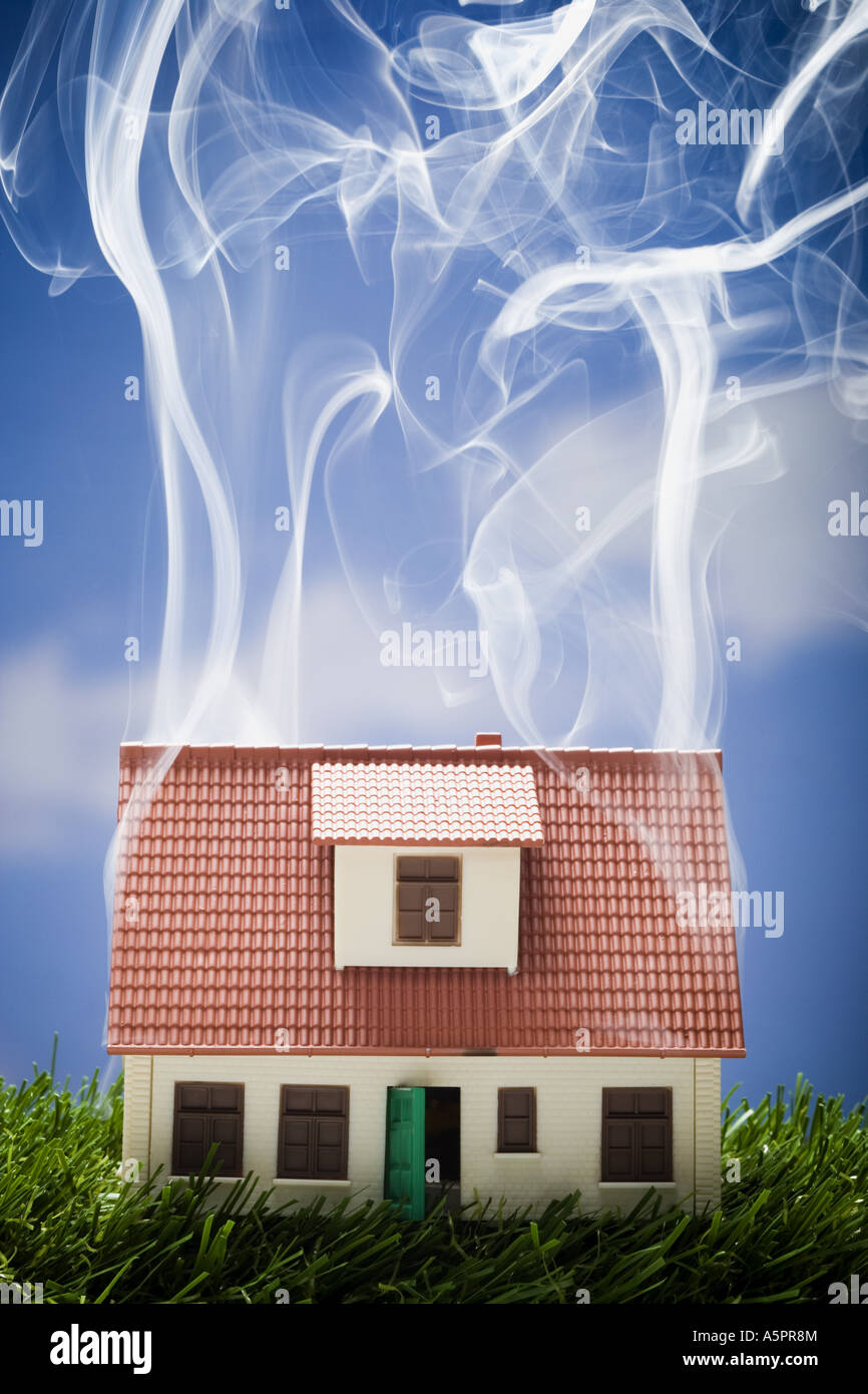 Smoking toy house Stock Photo - Alamy