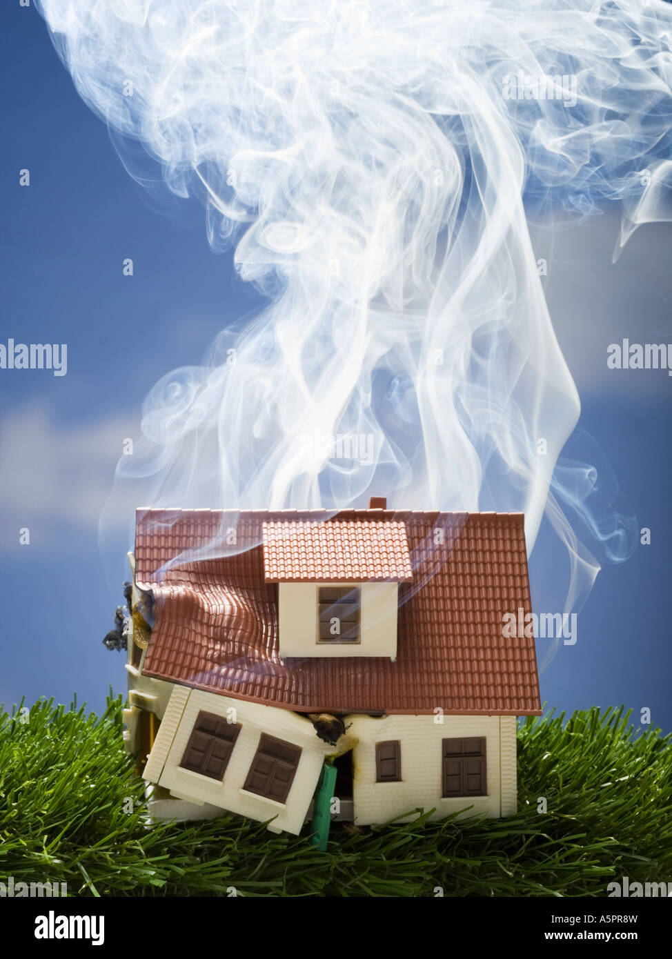 Smoking toy house Stock Photo - Alamy