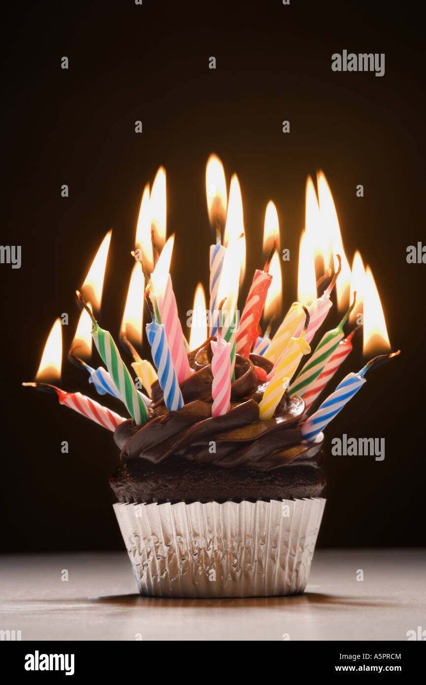 Cupcake with birthday candles Stock Photo - Alamy