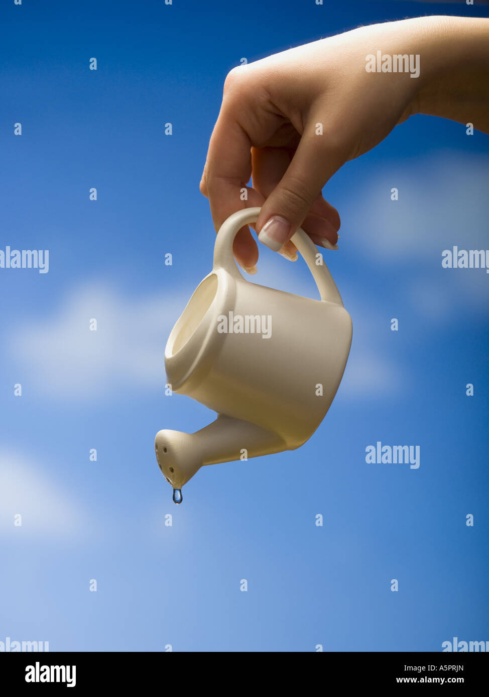 Last drop of water coming from watering can Stock Photo - Alamy