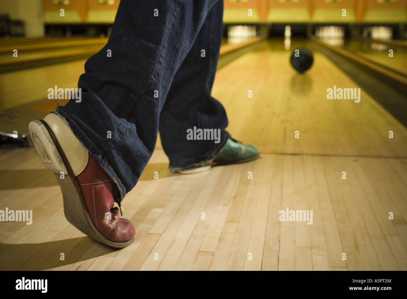 Low section view of a young man bowling at a bowling alley Stock Photo ...