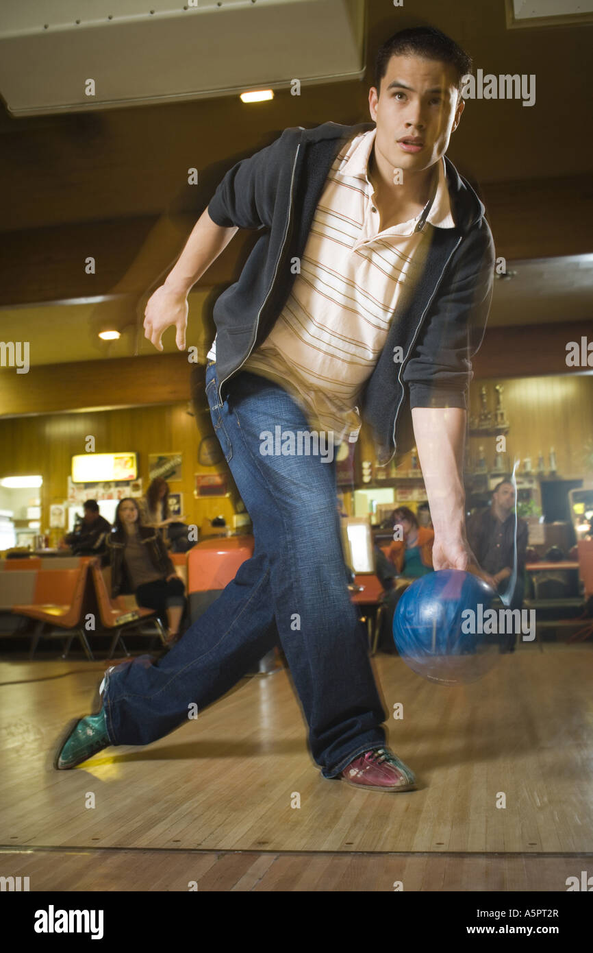 Young man bowling in a bowling alley Stock Photo - Alamy