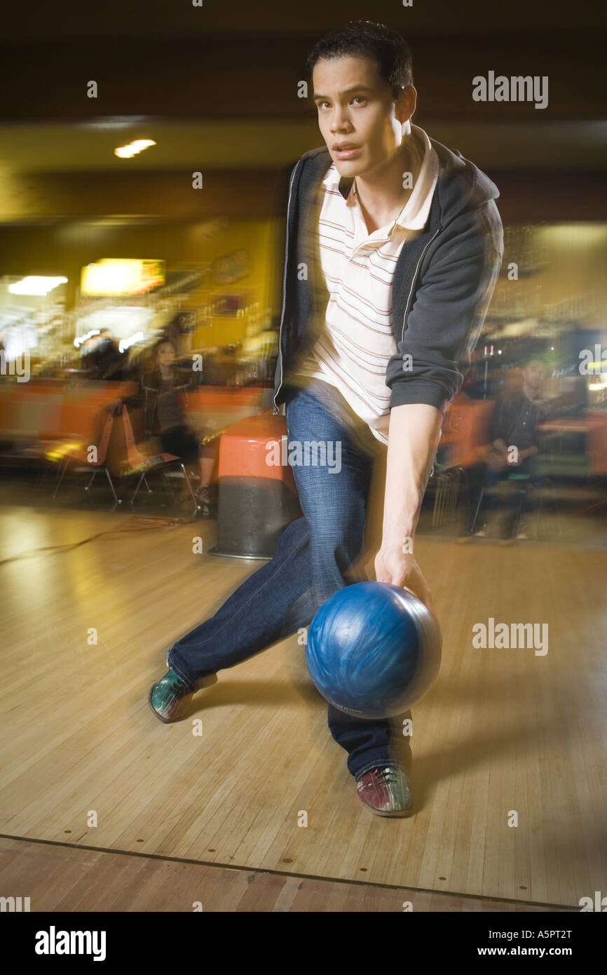 Young man bowling in a bowling alley Stock Photo - Alamy