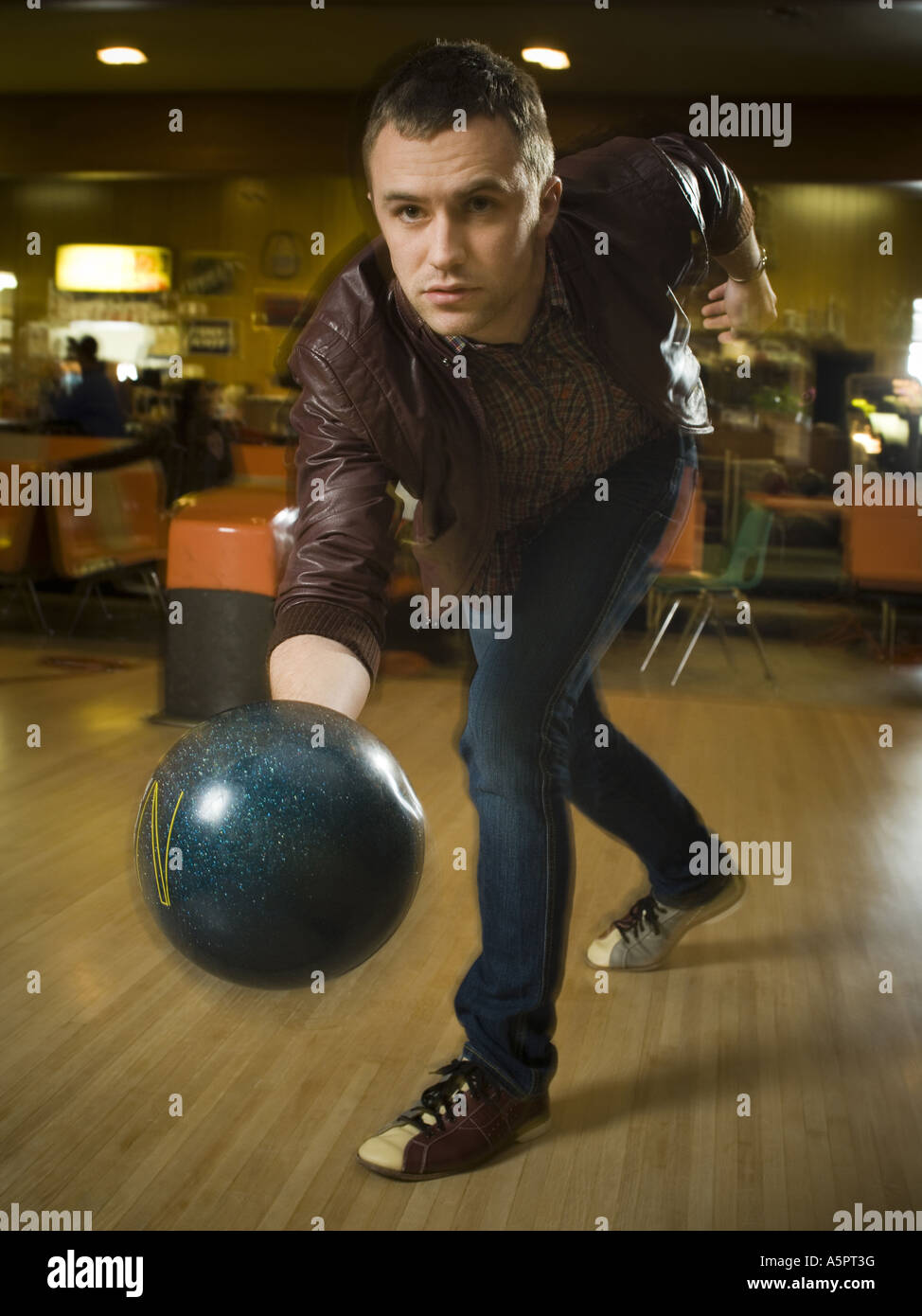 Young man bowling in a bowling alley Stock Photo - Alamy