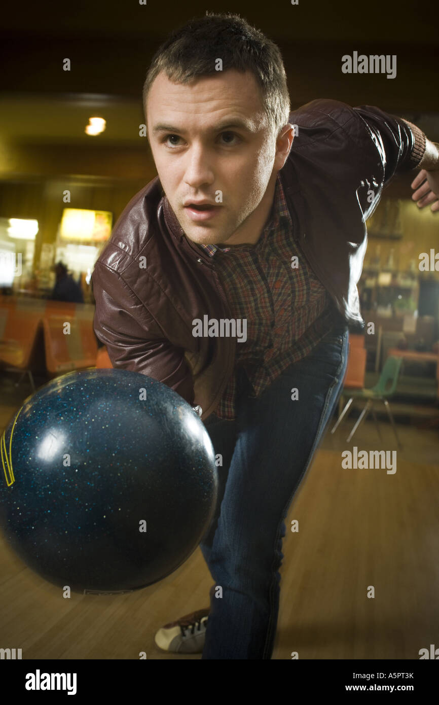 Young man bowling in a bowling alley Stock Photo - Alamy