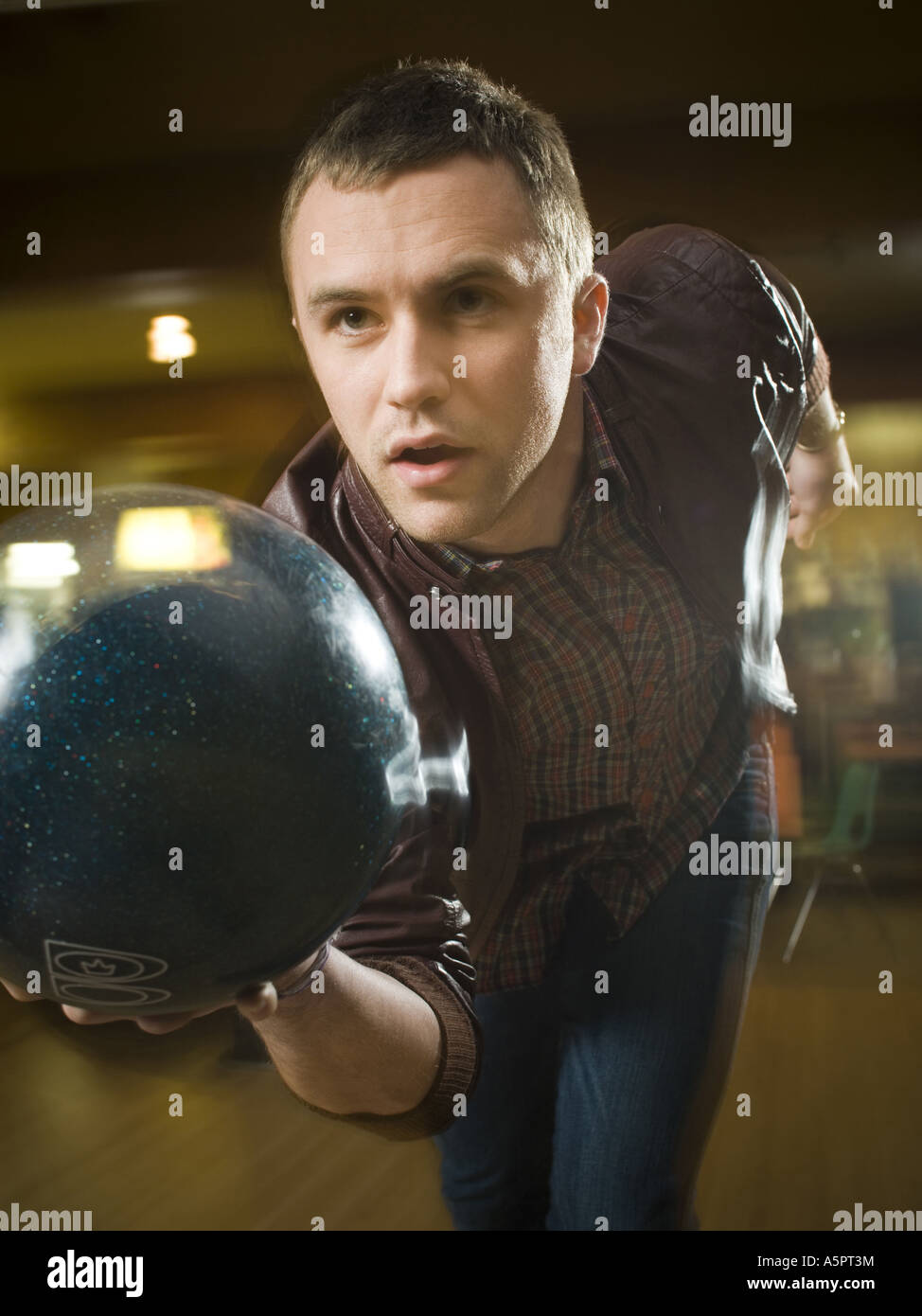 Young man bowling in a bowling alley Stock Photo - Alamy
