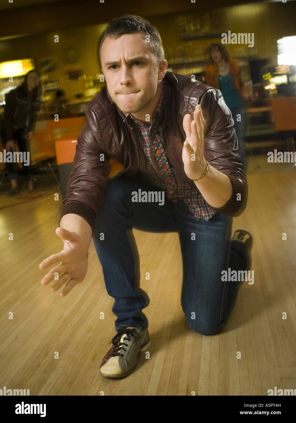 Young man cheering in excitement at a bowling alley Stock Photo - Alamy