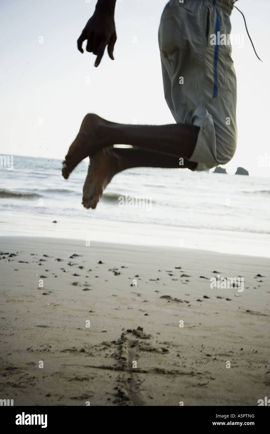 Low section view of a man jumping Stock Photo - Alamy