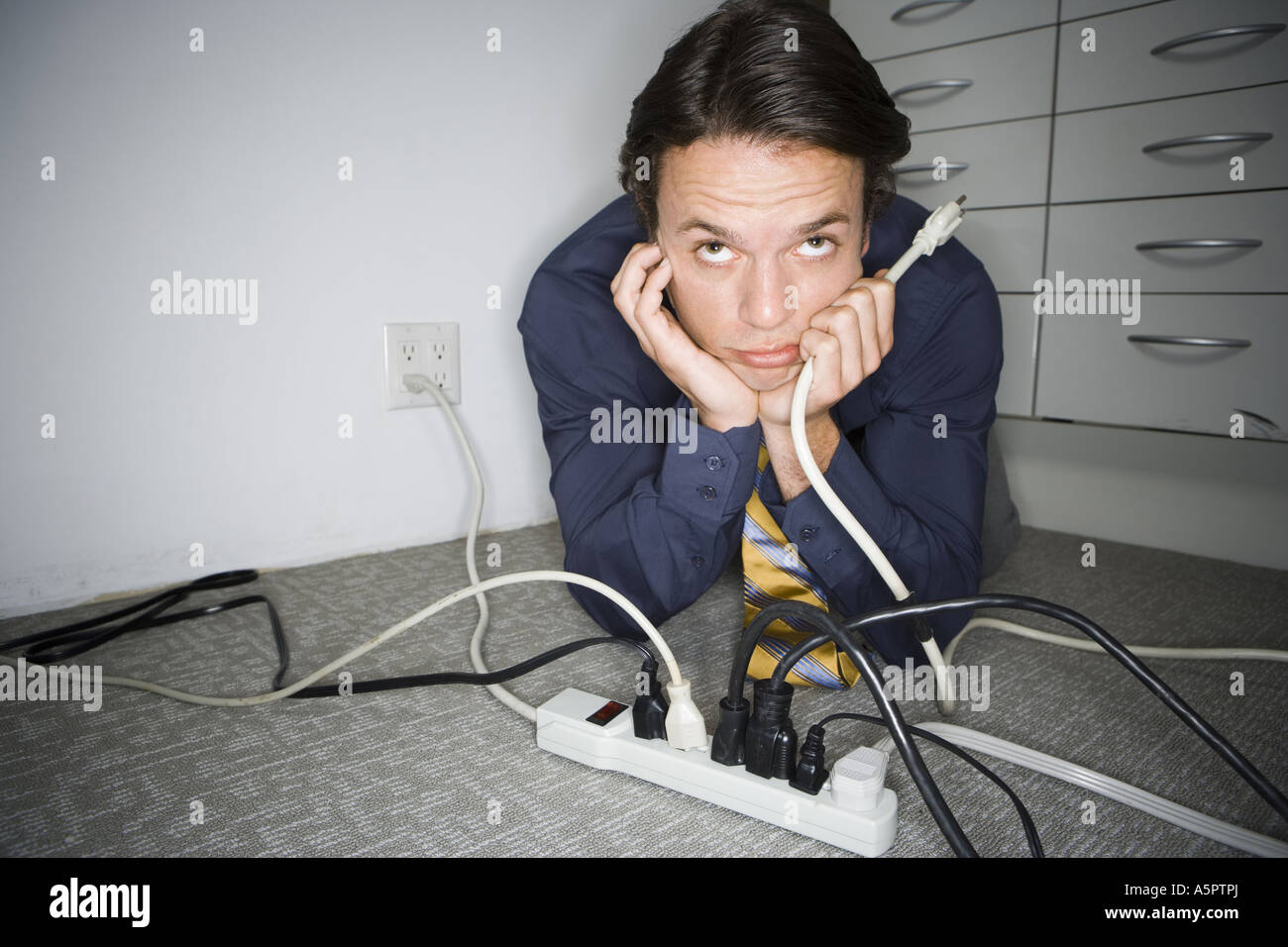 Close up of a young man holding a plug Stock Photo - Alamy