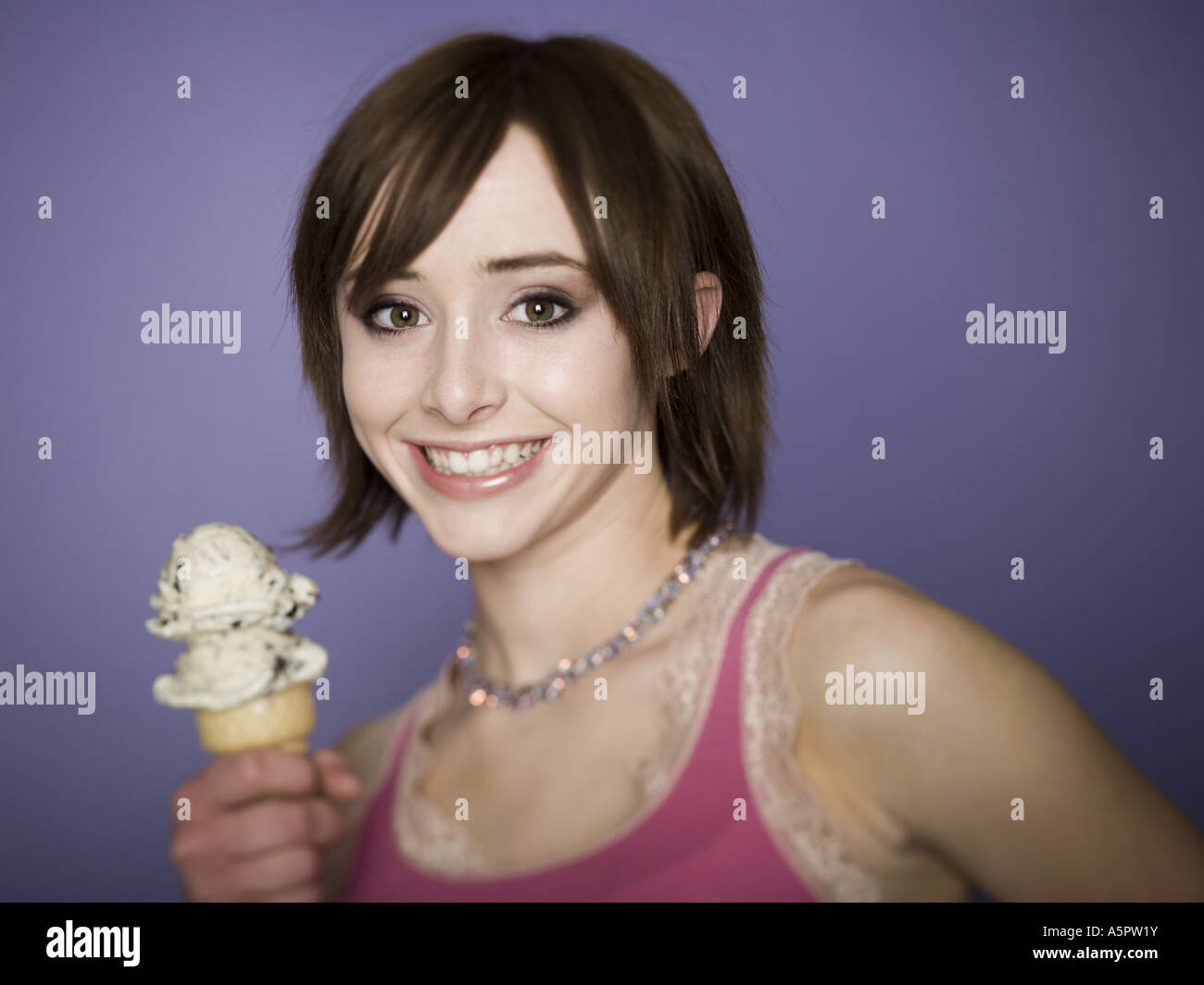 Portrait of a teenage girl holding an ice cream cone Stock Photo - Alamy