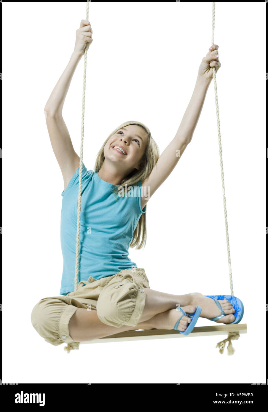 Portrait of a girl swinging on a rope swing Stock Photo - Alamy