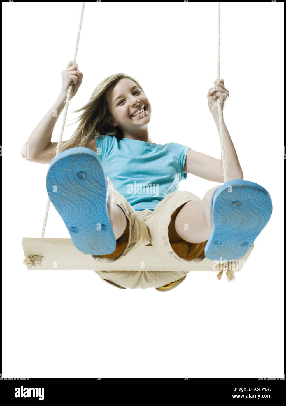 Portrait of a girl swinging on a rope swing Stock Photo - Alamy