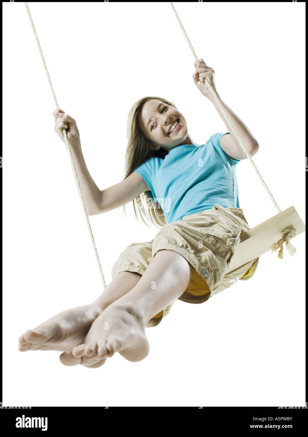 Portrait of a girl swinging on a rope swing Stock Photo - Alamy