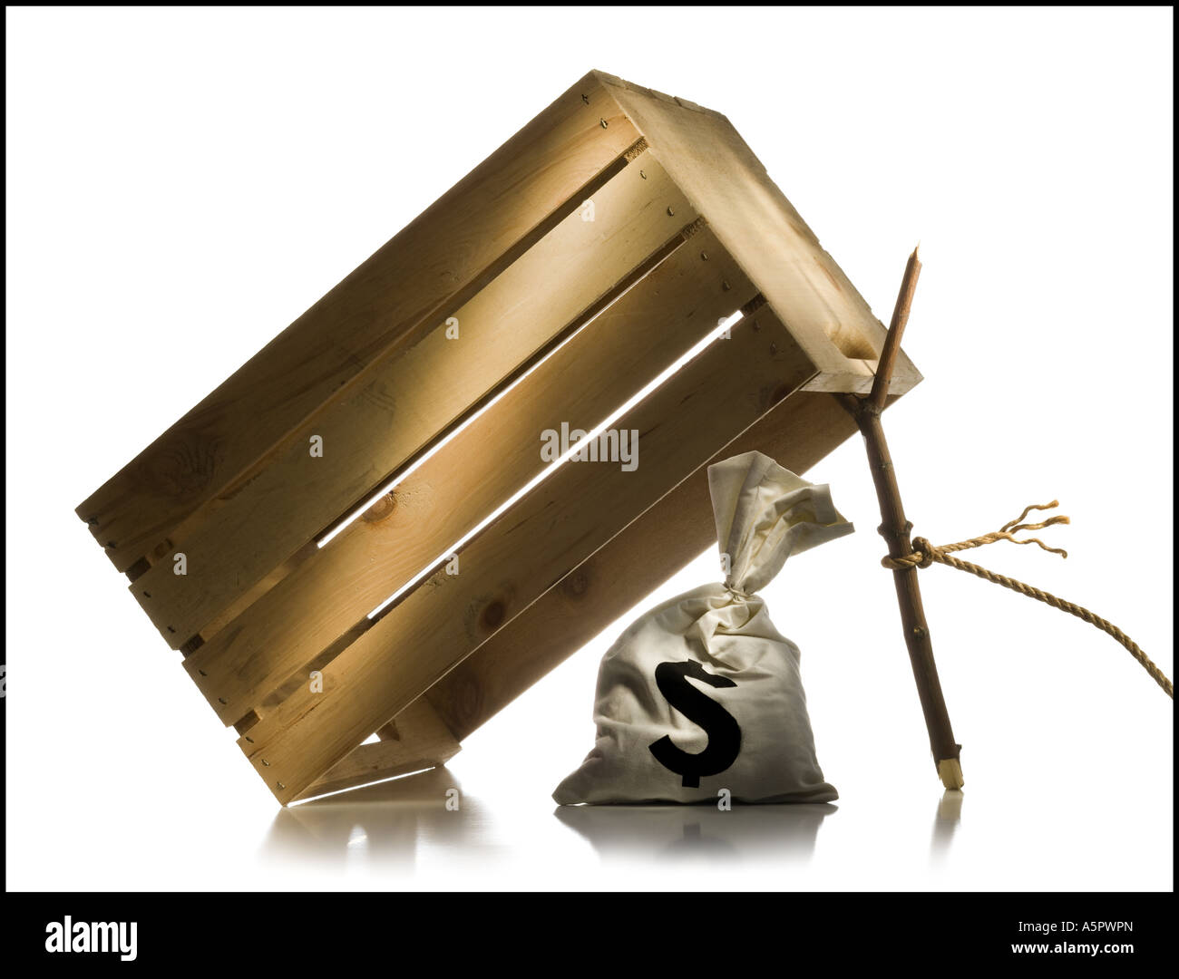 Money bag placed under wooden crate trap Stock Photo - Alamy