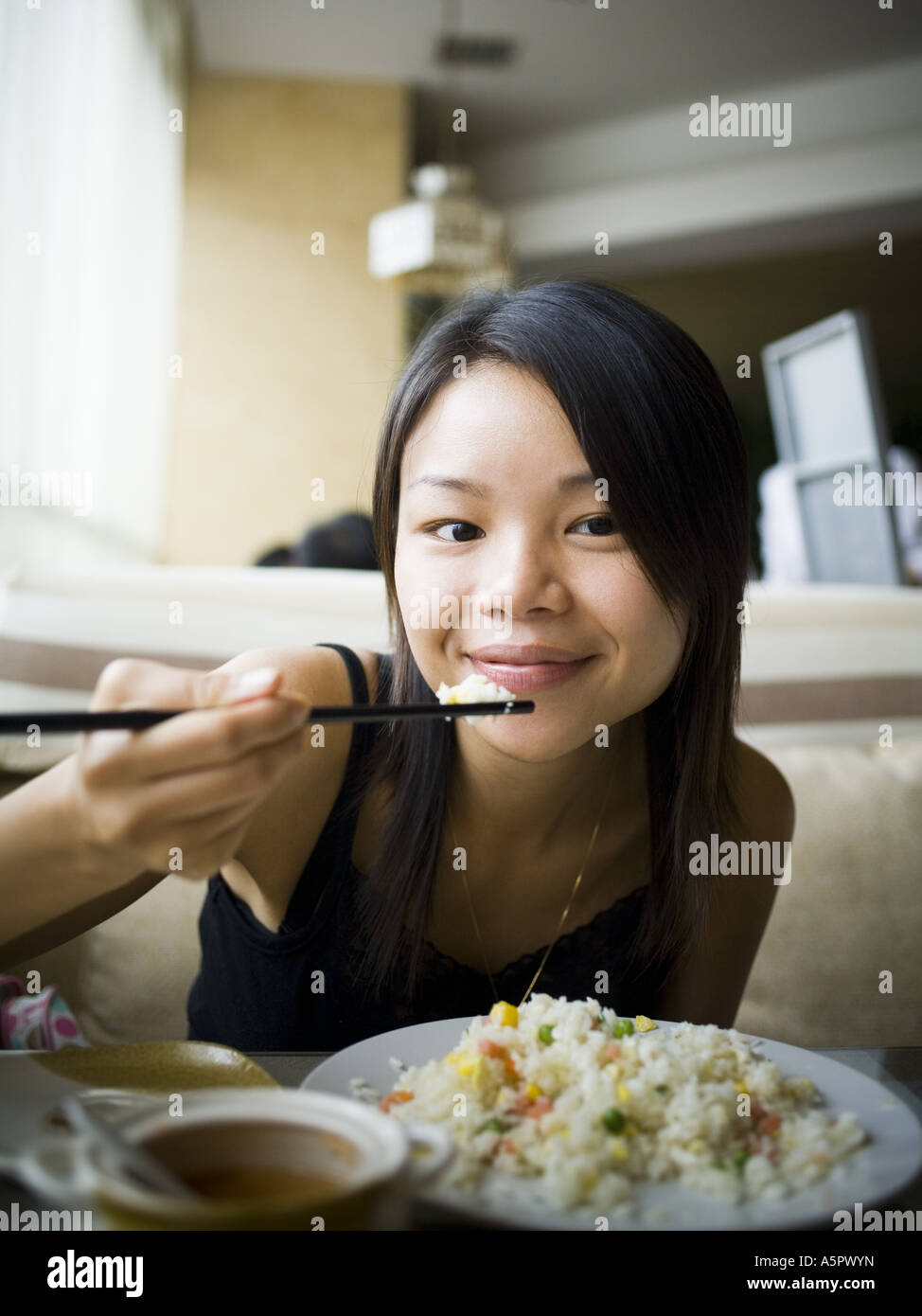 Woman eating at a Chinese food restaurant Stock Photo - Alamy