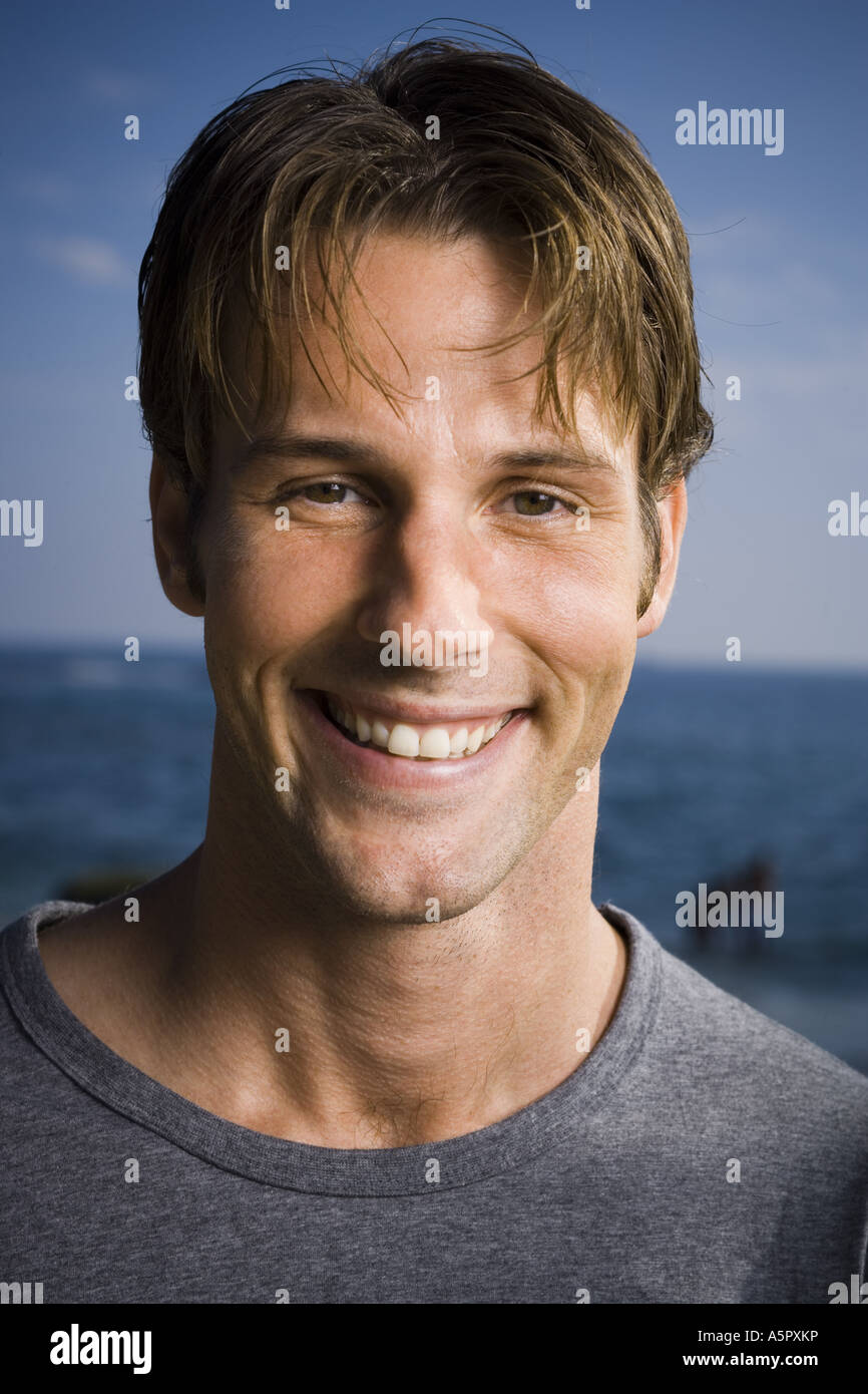 Smiling man on beach Stock Photo - Alamy