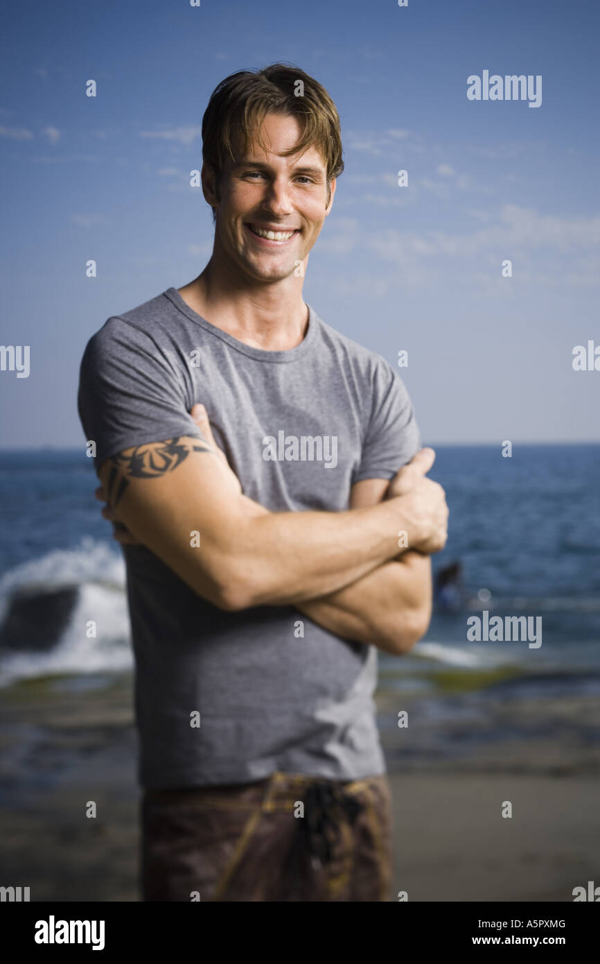 Smiling man on beach Stock Photo - Alamy