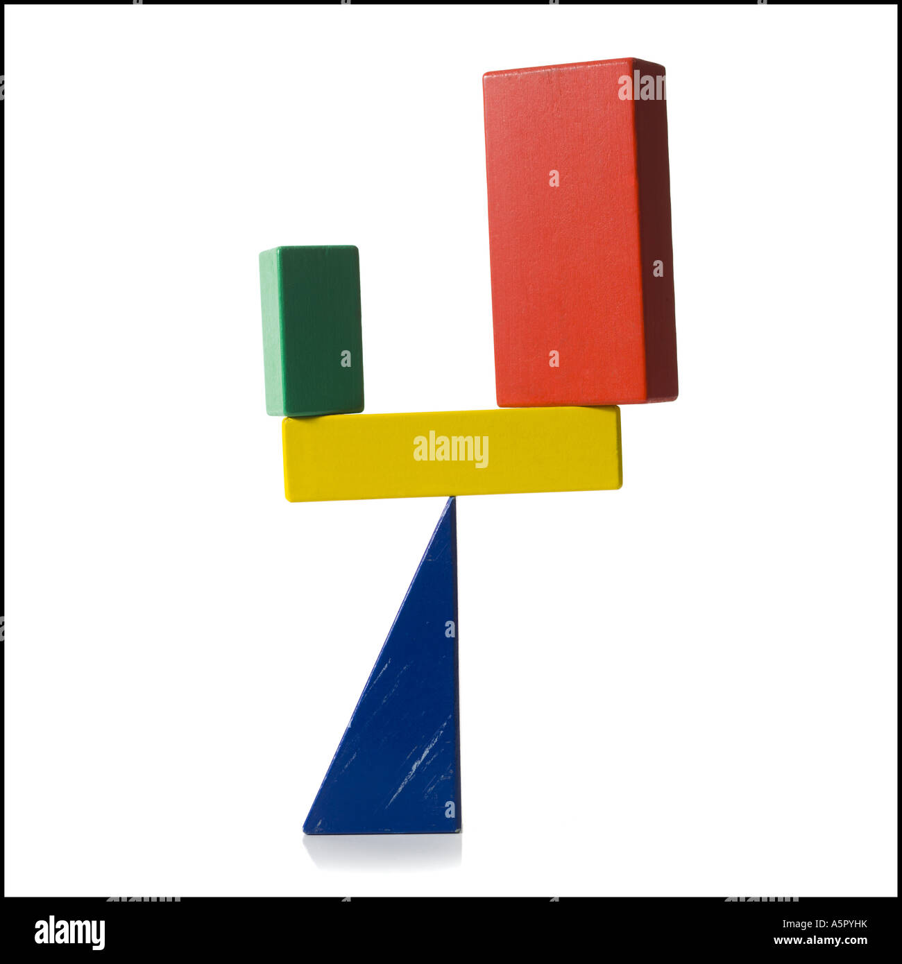 Wooden blocks precariously balancing on triangle Stock Photo - Alamy