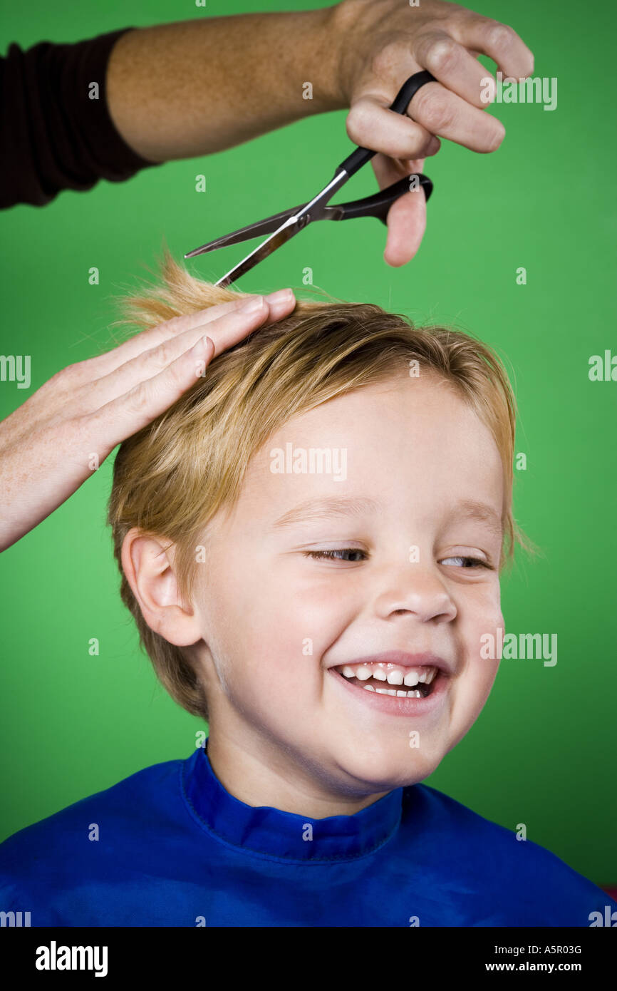 Boy having his hair cut smiling Stock Photo - Alamy