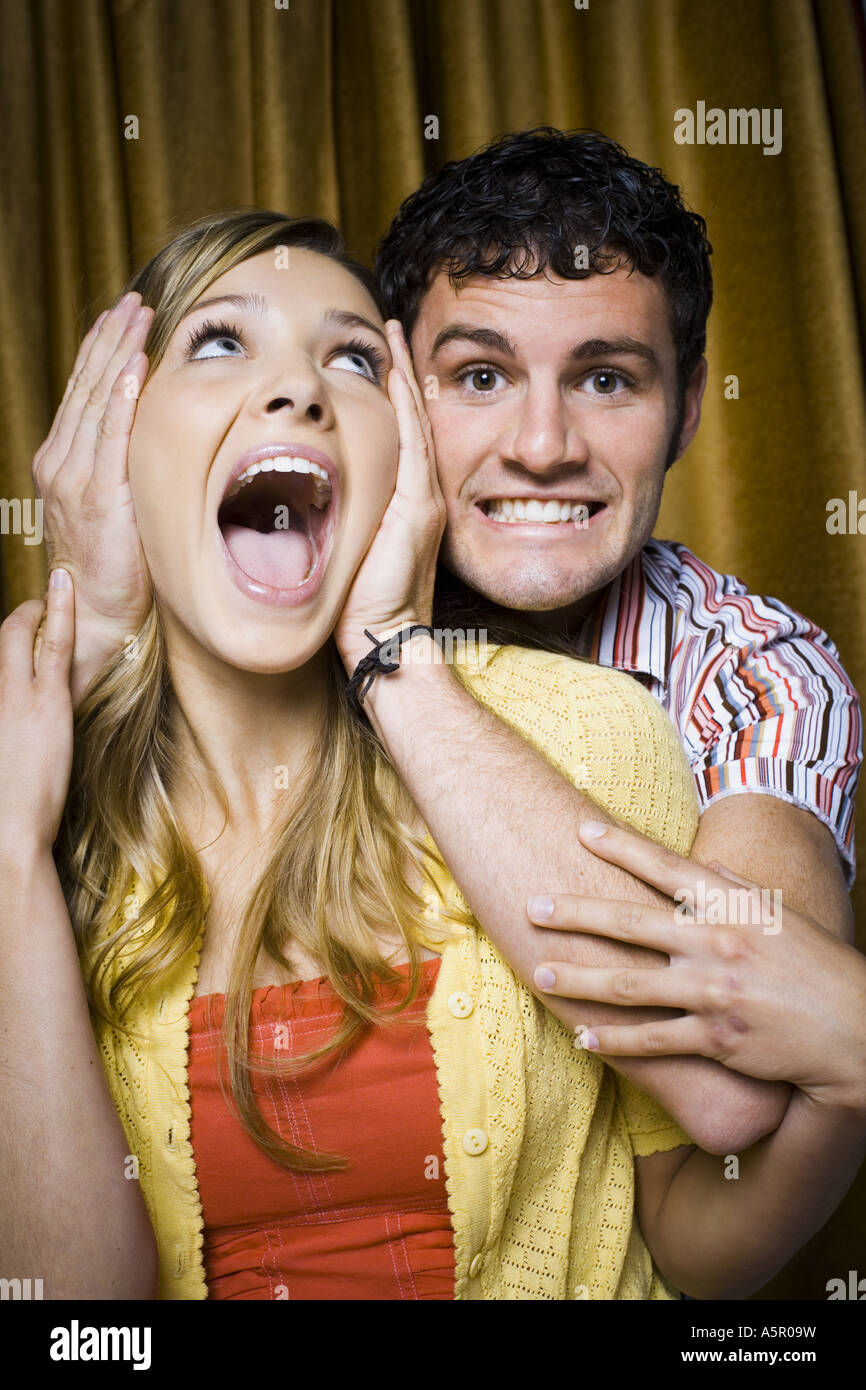 Couple in photo booth laughing Stock Photo - Alamy