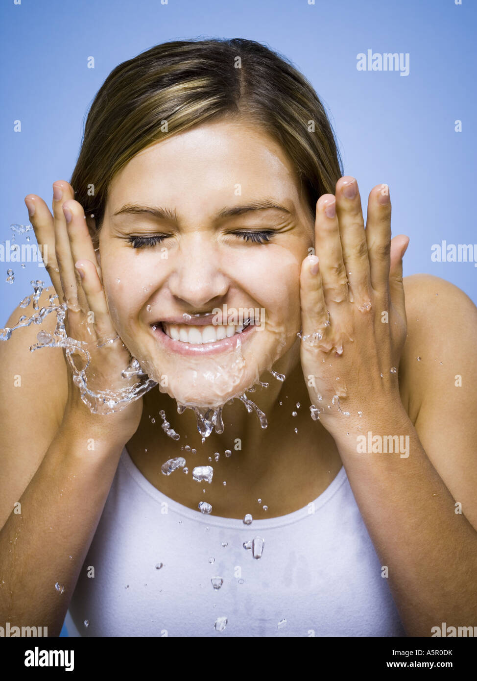 Woman washing face Stock Photo - Alamy
