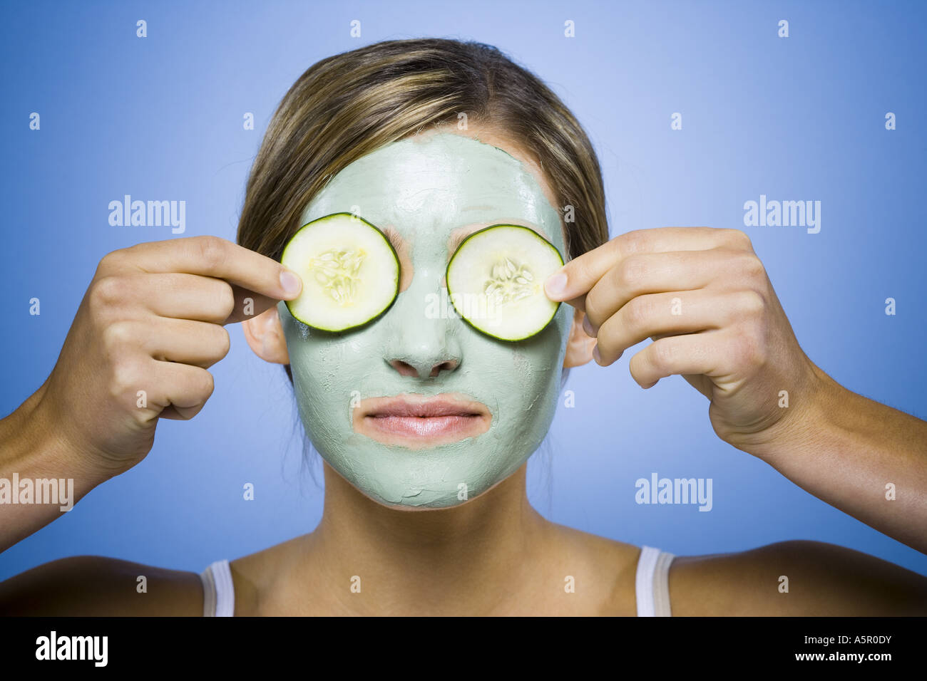 Woman with facial mask and cucumber slices Stock Photo - Alamy