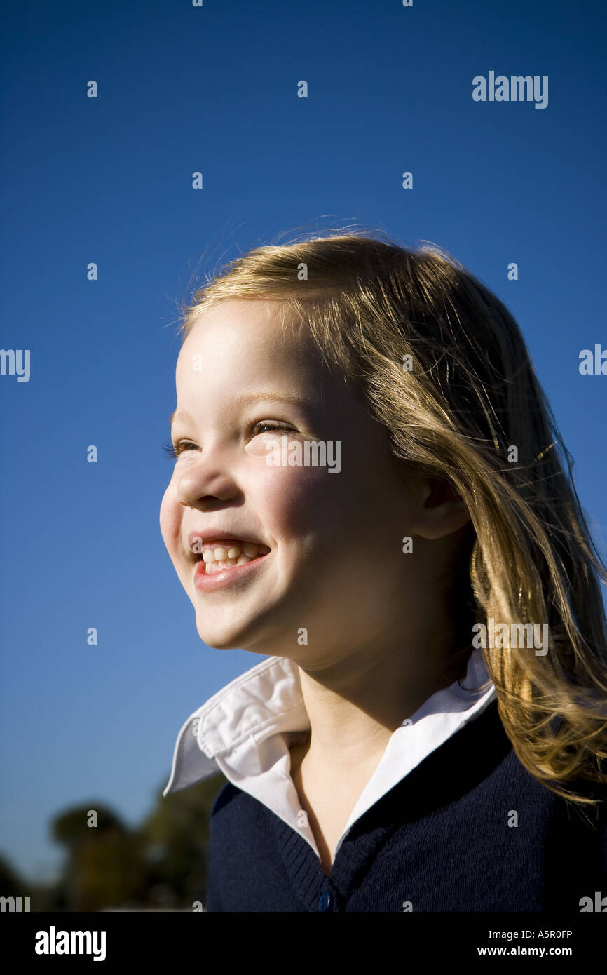 Girl smiling blue sky Stock Photo - Alamy