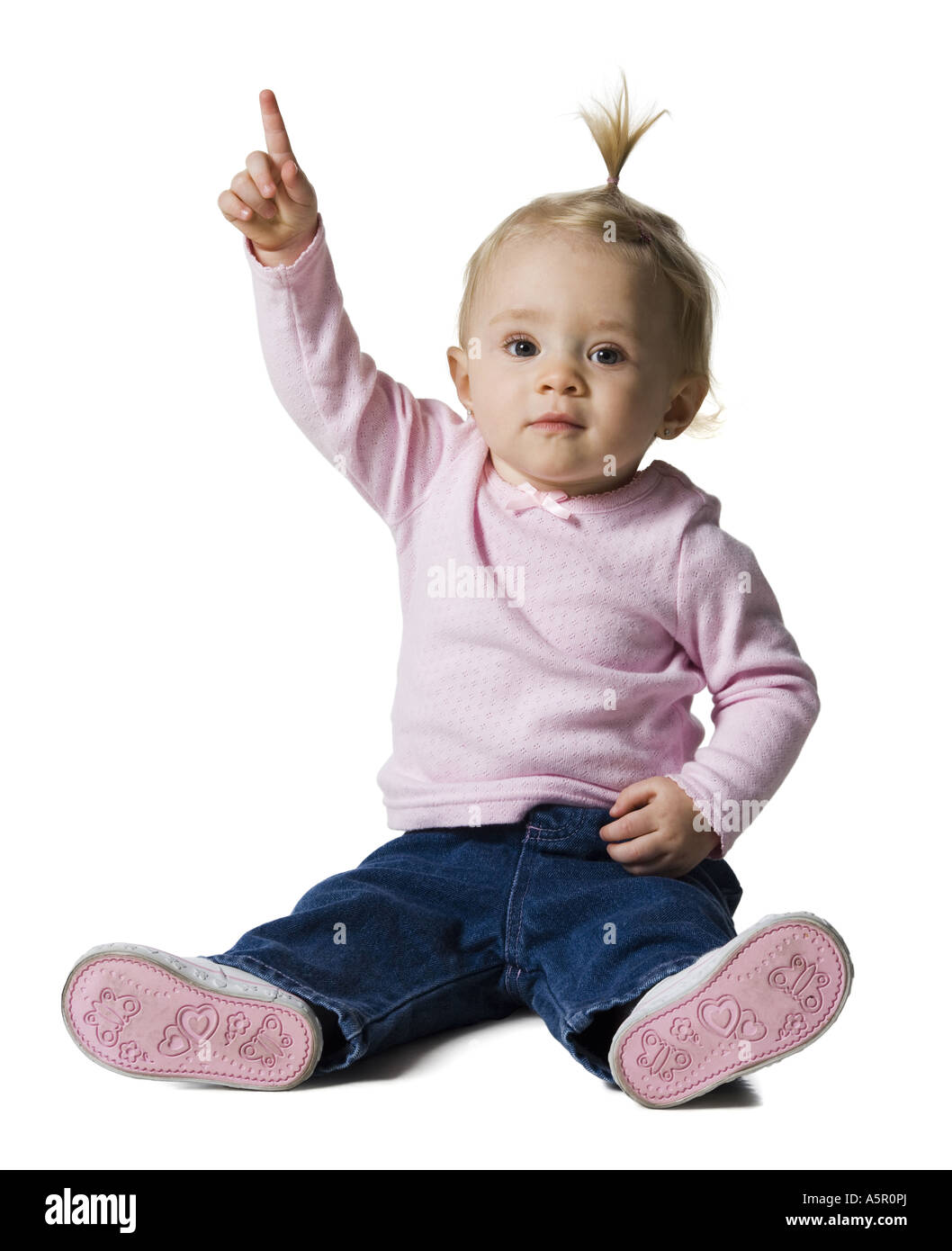 Baby Girl with ponytail pointing up Stock Photo - Alamy