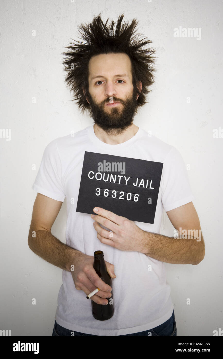 Mug shot of man with cigarette and beer bottle Stock Photo - Alamy