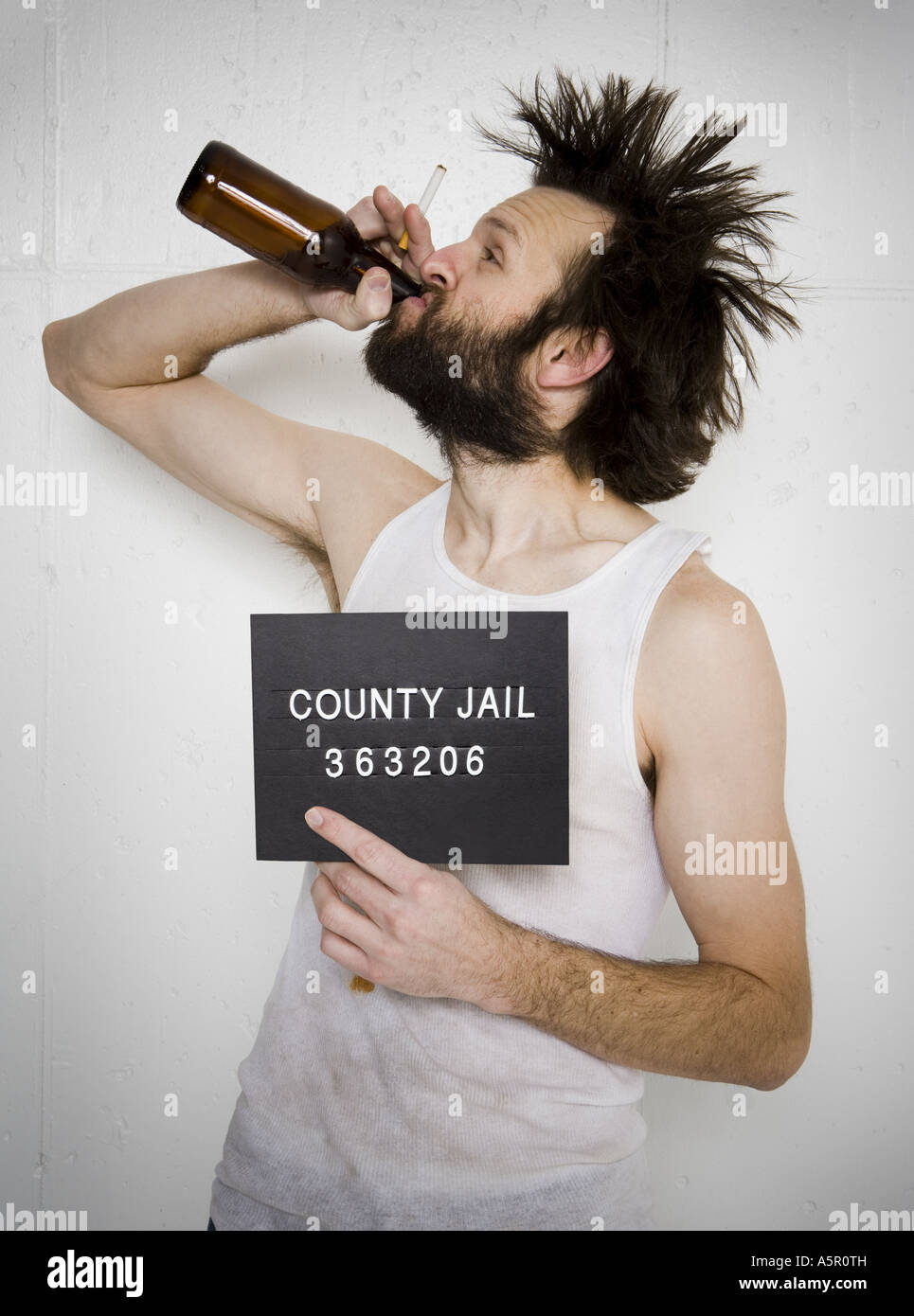 Man drinking beer holding blank sign and cigarette Stock Photo - Alamy