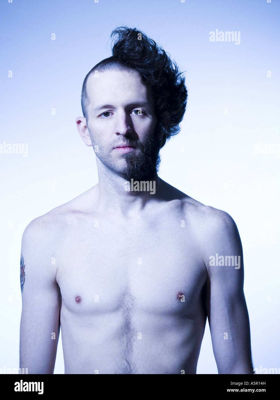 Man with half shaved hair and beard Stock Photo - Alamy