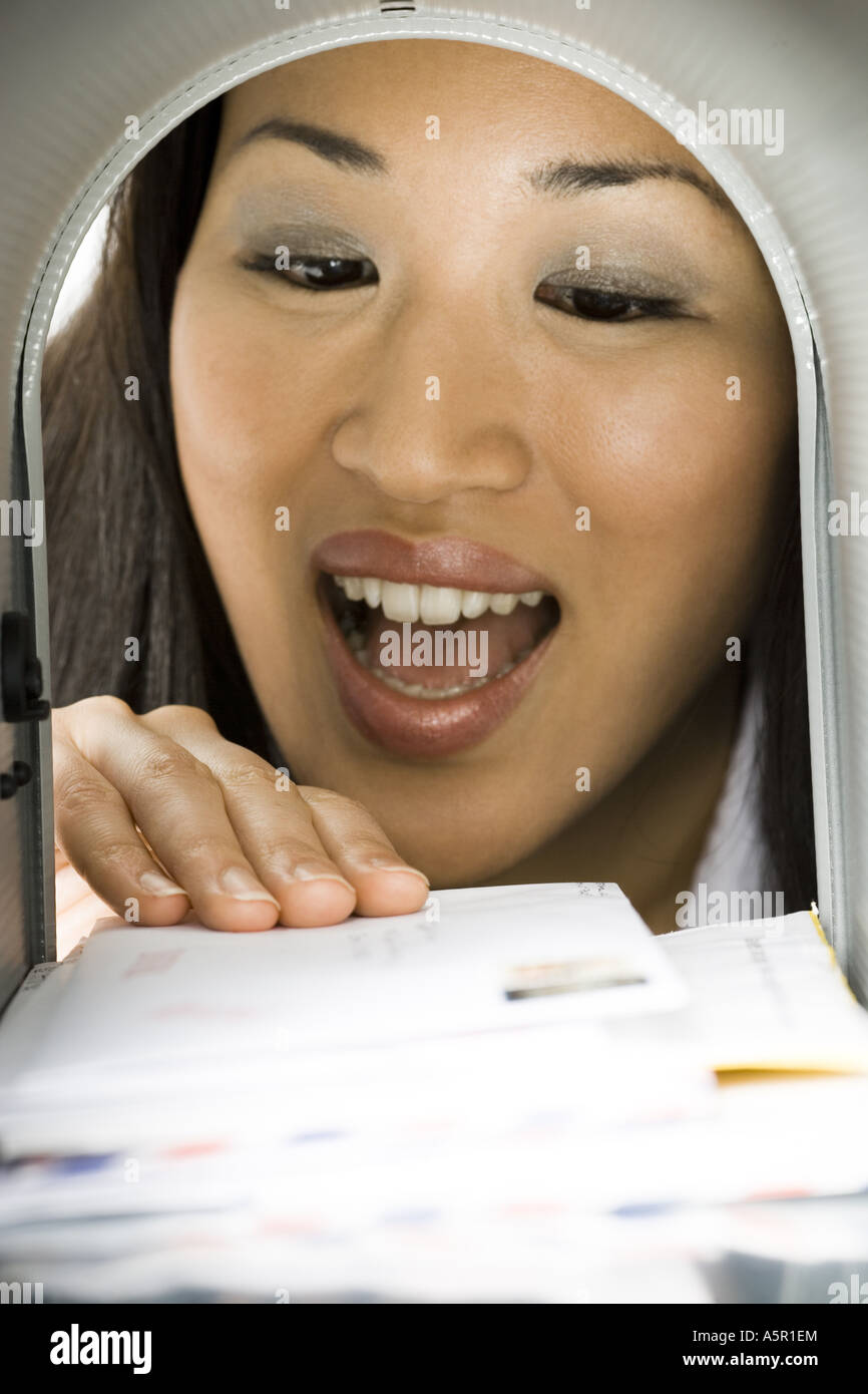 Close up of woman getting letters from mailbox Stock Photo - Alamy
