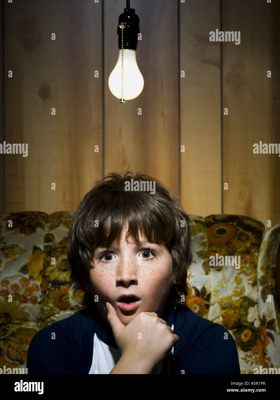 Close up of boy with light bulb Stock Photo - Alamy
